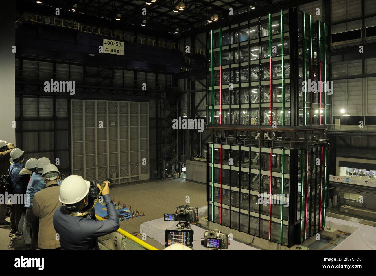 Redand green lights are lit on about 27-meter-high model of a building ...