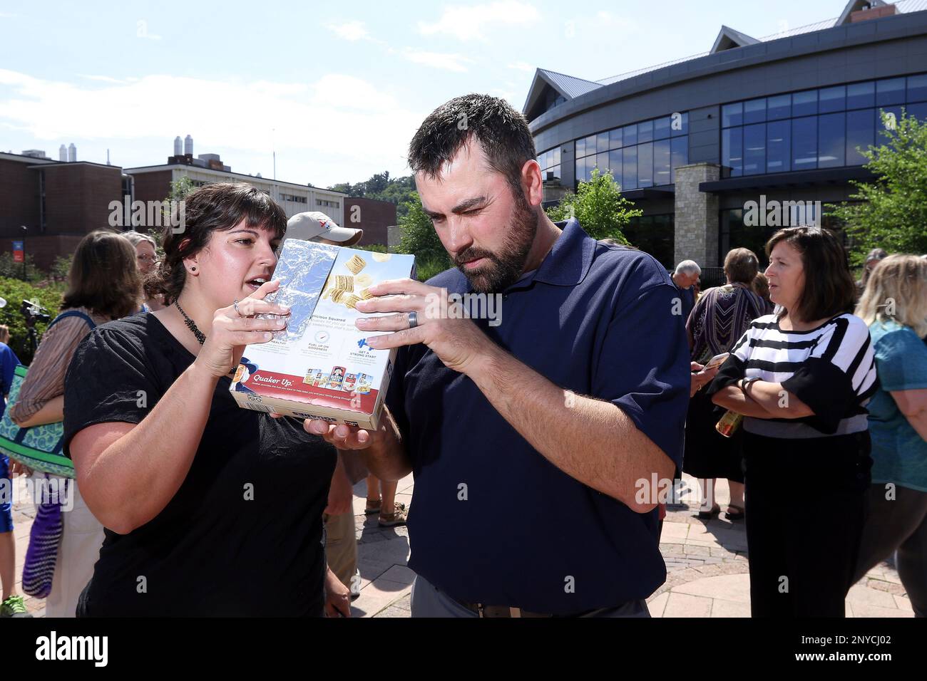 Ben and Kathy Binder look at the eclipse through a homemade pinhole ...