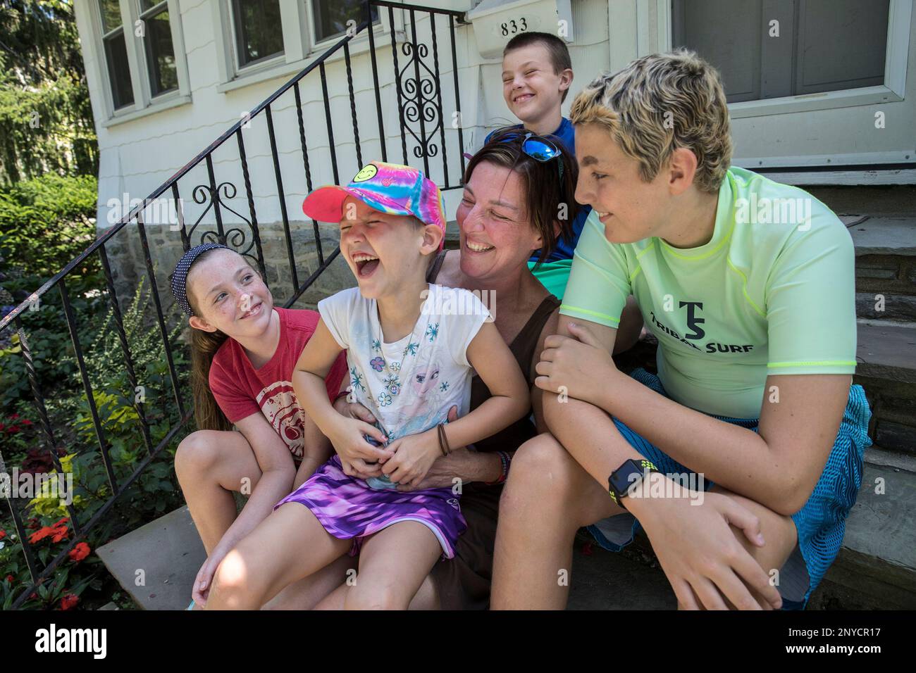 The McGonigle family sits on the front steps of their Havertown home ...