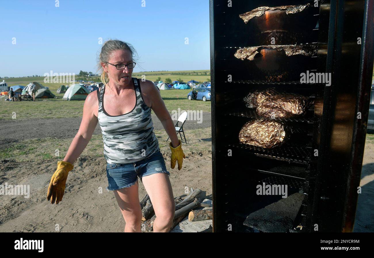 In this Aug. 20, 2017 photo, Collette Murray mans a smoker in the Over ...