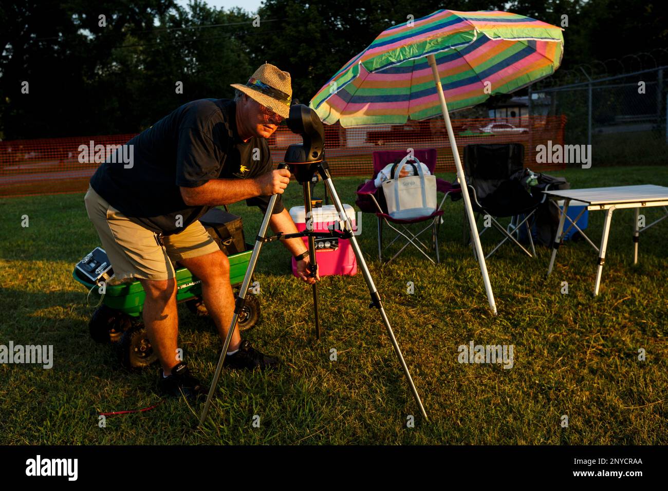John Fertig, from Marietta, Ga., sets up a tripod and telescope in ...