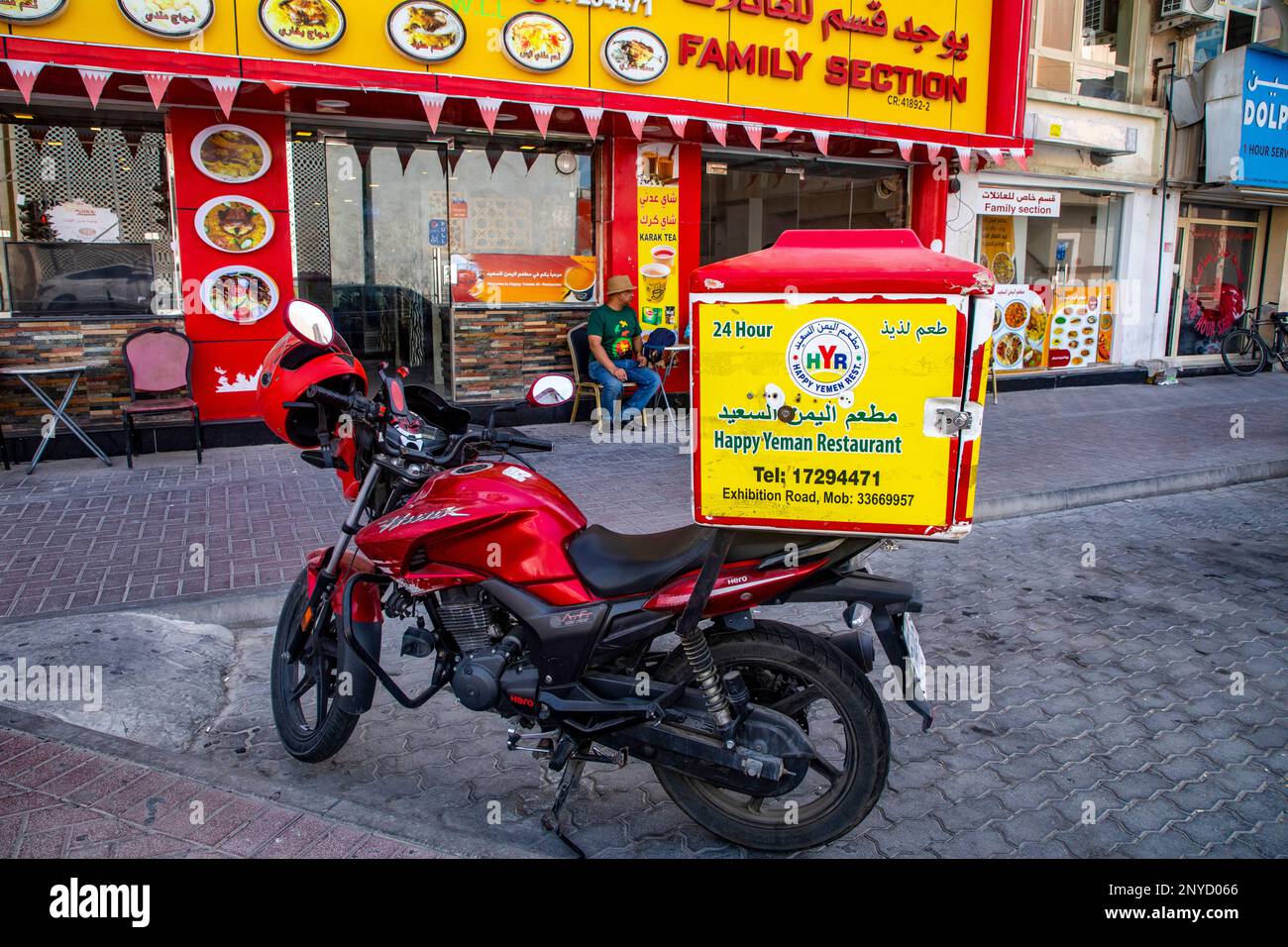 A food delivery motor bike of Happy Yeman restaurant parked in front of ...