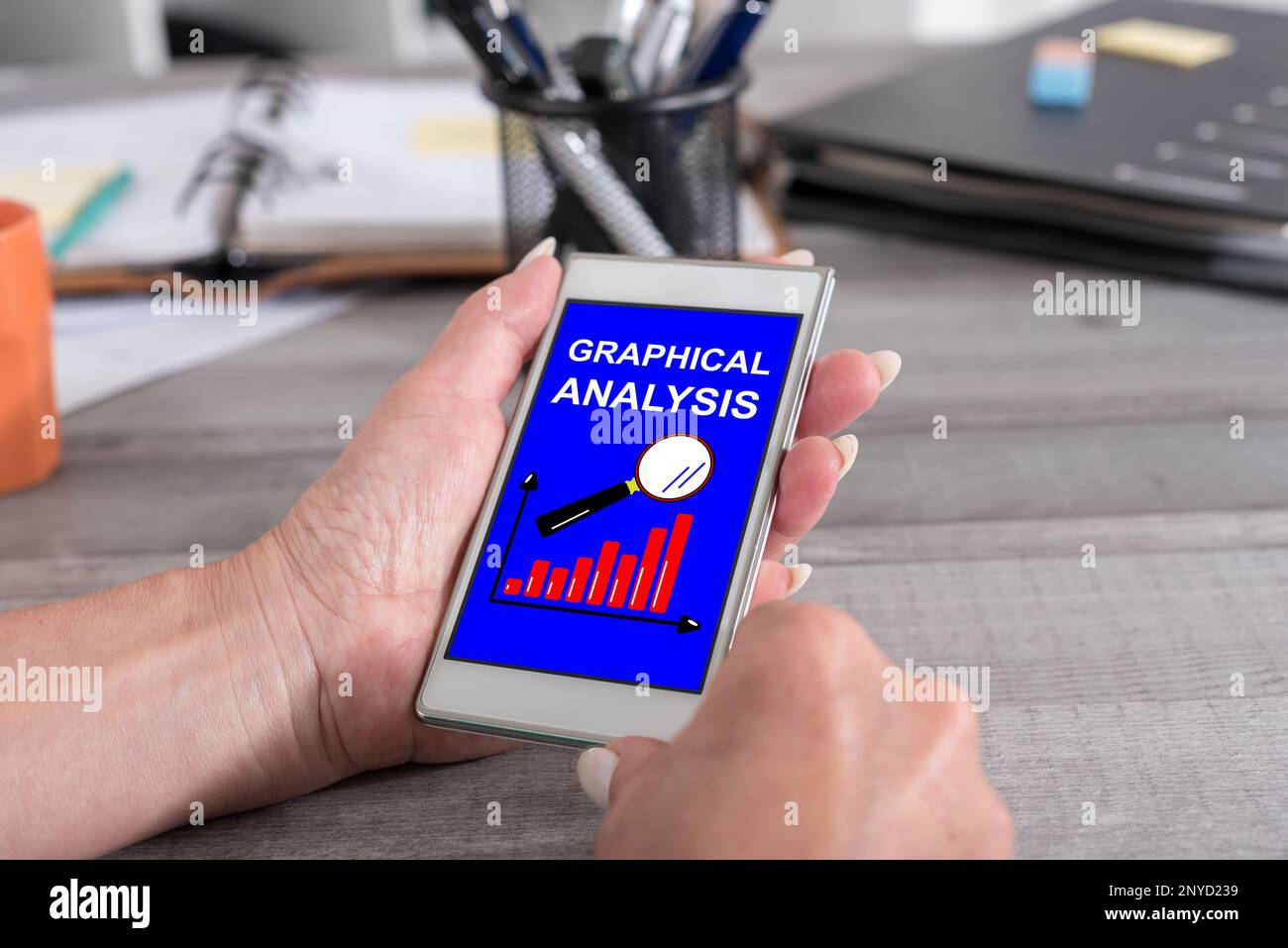 Female hand holding a smartphone with graphical analysis concept Stock ...