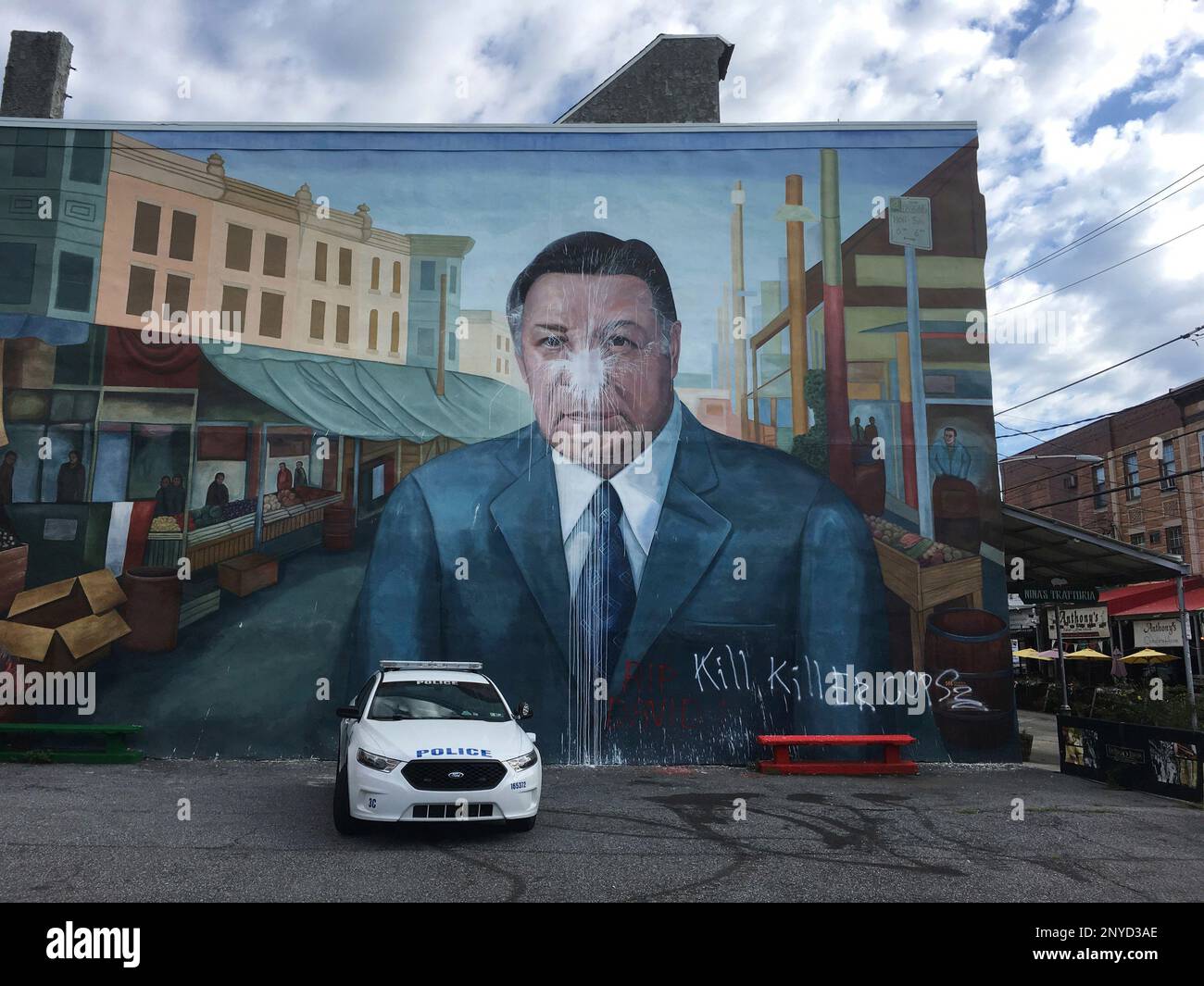 A police car is parked in front of a mural of former Philadelphia Mayor ...