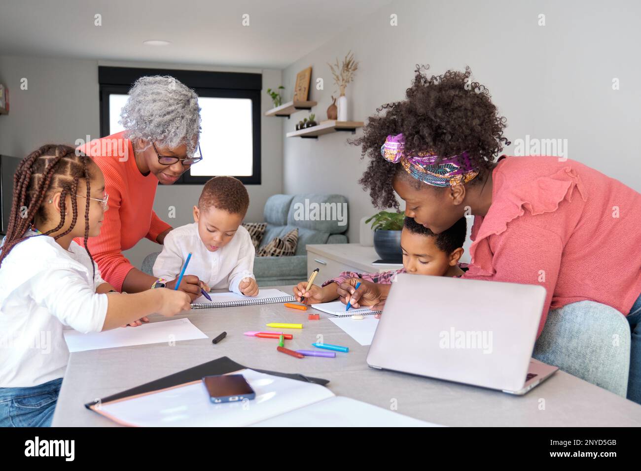 African mothers helping children homework hi-res stock photography and images - Alamy