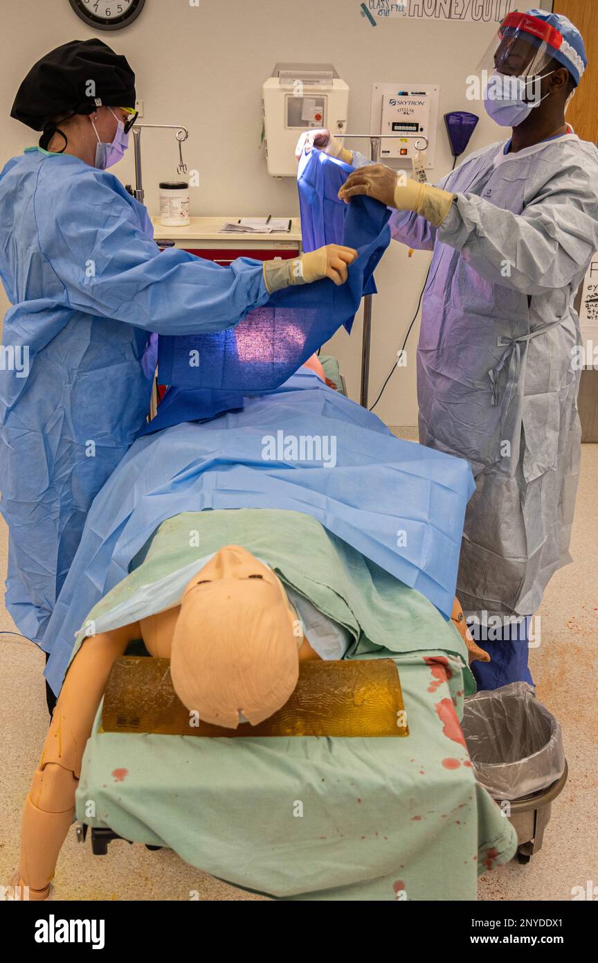 Instructors act as surgeons during a mock surgery while 68D operating ...