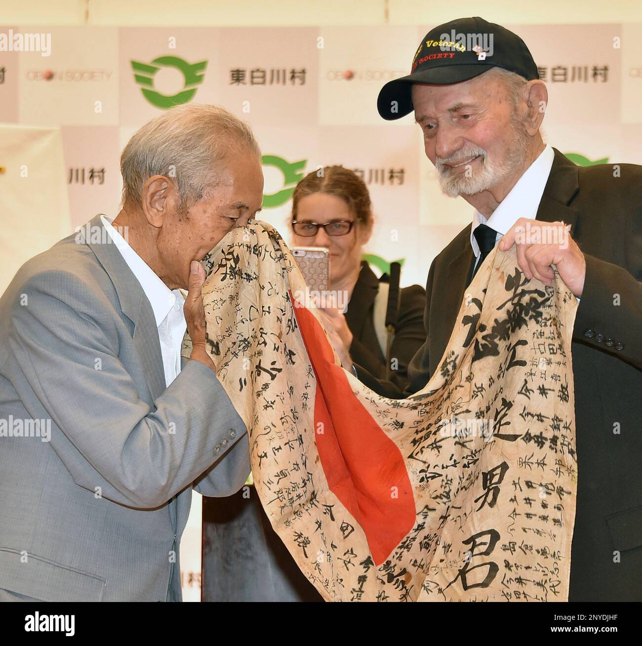 Marvin Strombo(R) , a 93-year-old former Marine, hands Japanese flag ...