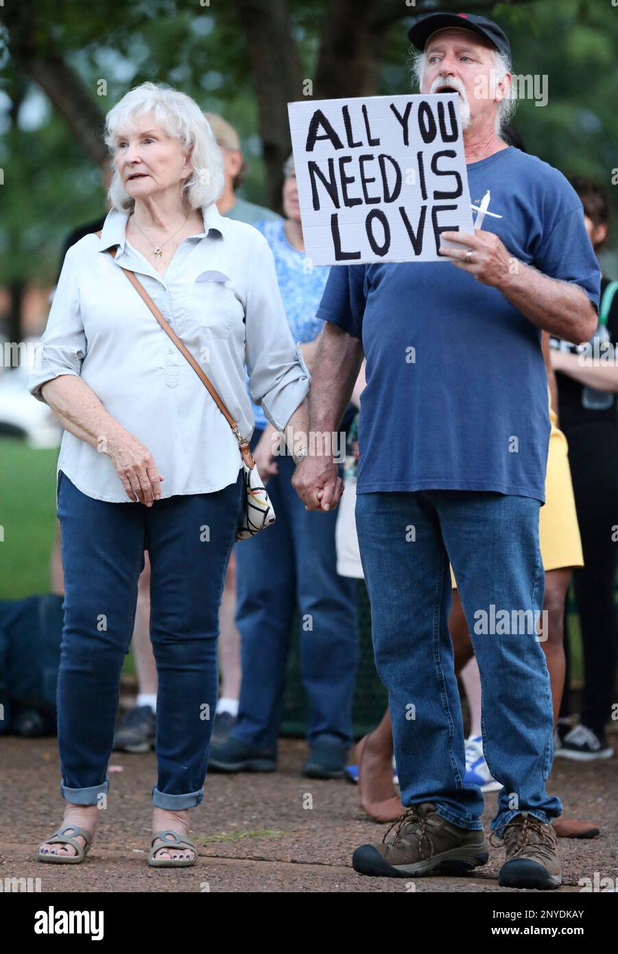 Sara Shapiro, left, and Kerry Shapiro hold hands during a gathering ...