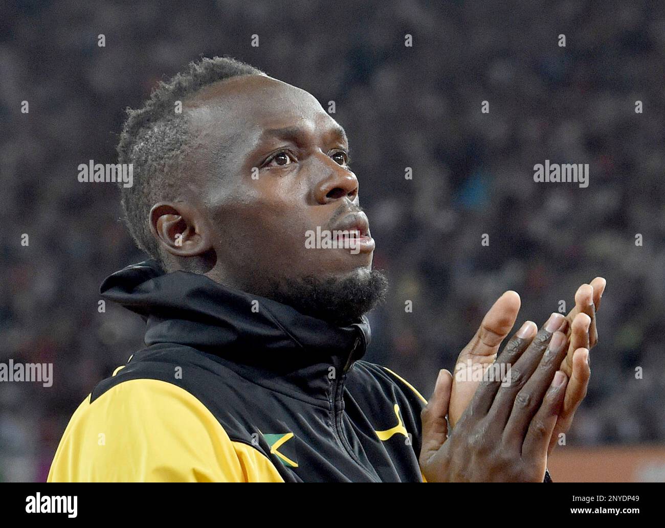 Jamaica's Usain Bolt falls down on the track during a retirement ...