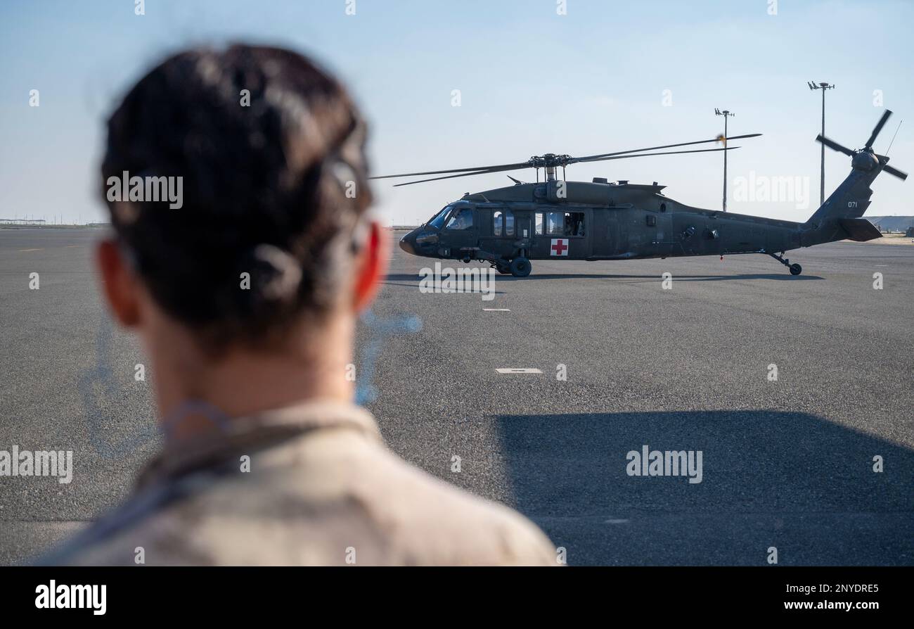 A Canadian Army medic watches as a U.S. Army UH-60 Blackhawk helicopter ...