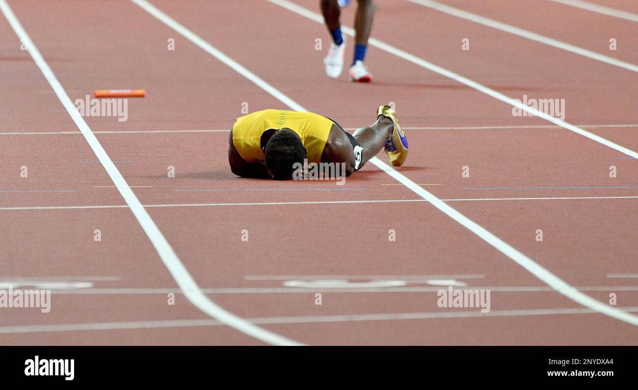 Jamaica's Usain Bolt falls down on the track caused by injury in the ...