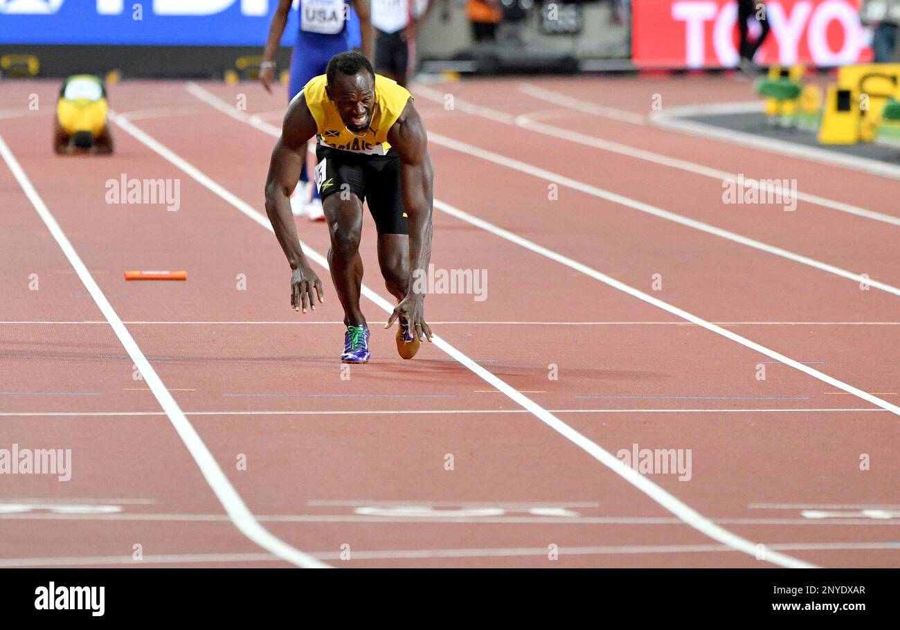 Jamaica's Usain Bolt falls down on the track caused by injury in the ...