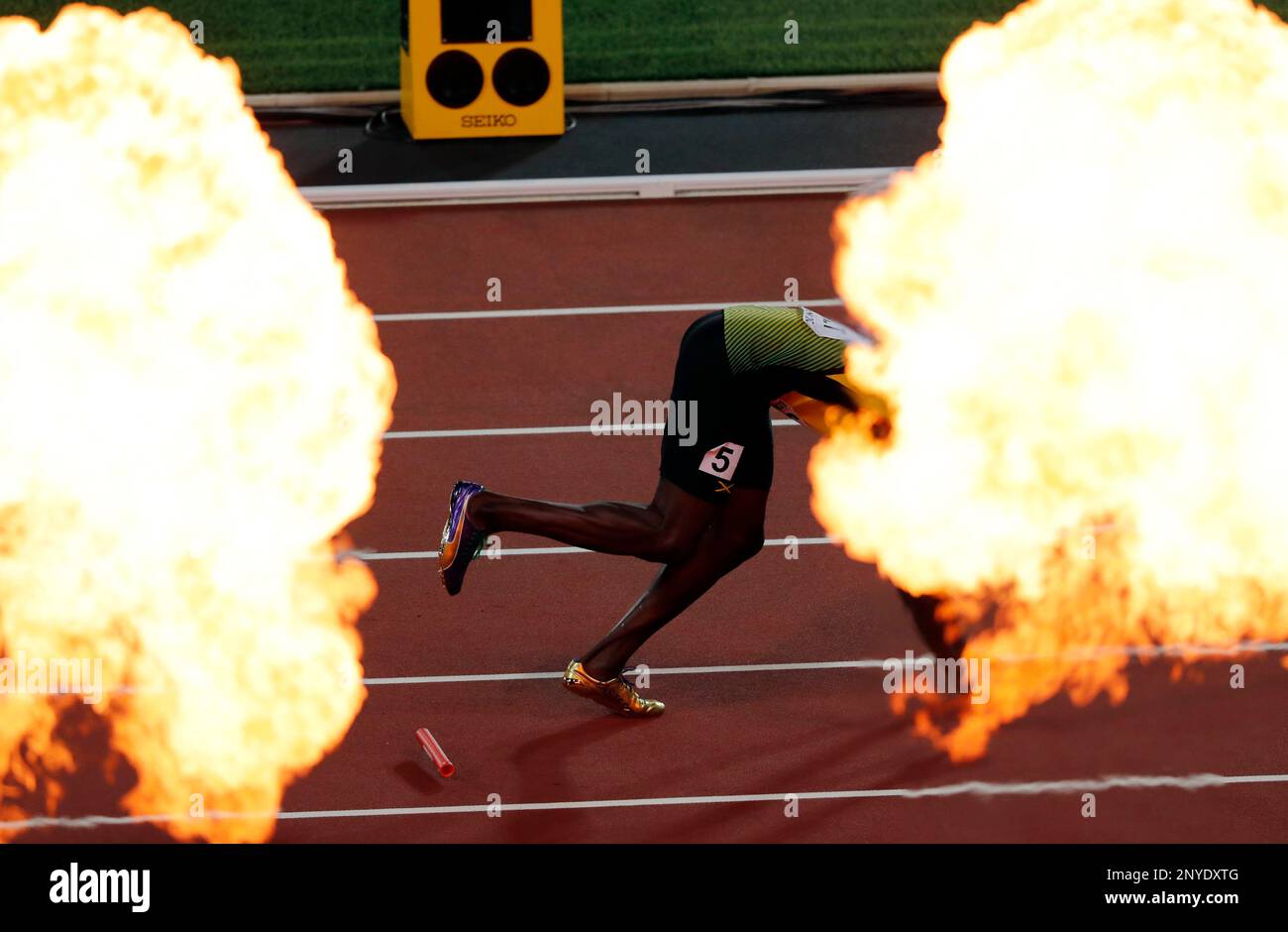 Fireworks for the winner goes off as Jamaica's Usain Bolt falls after ...