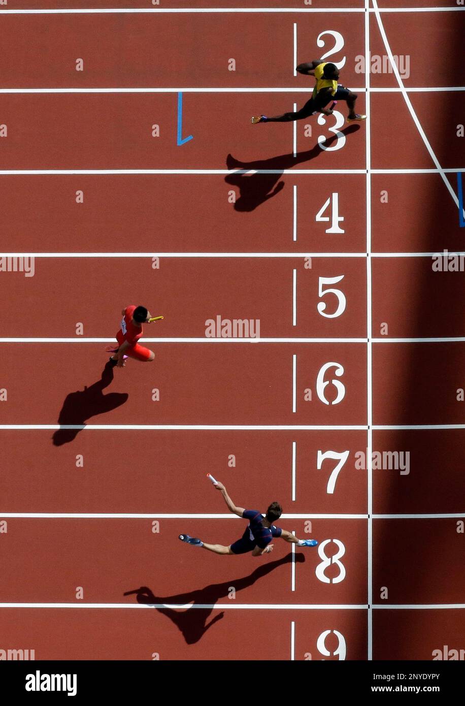 Jamaica's Usain Bolt, top, anchors the Men's 4x100m relay team to a win ...
