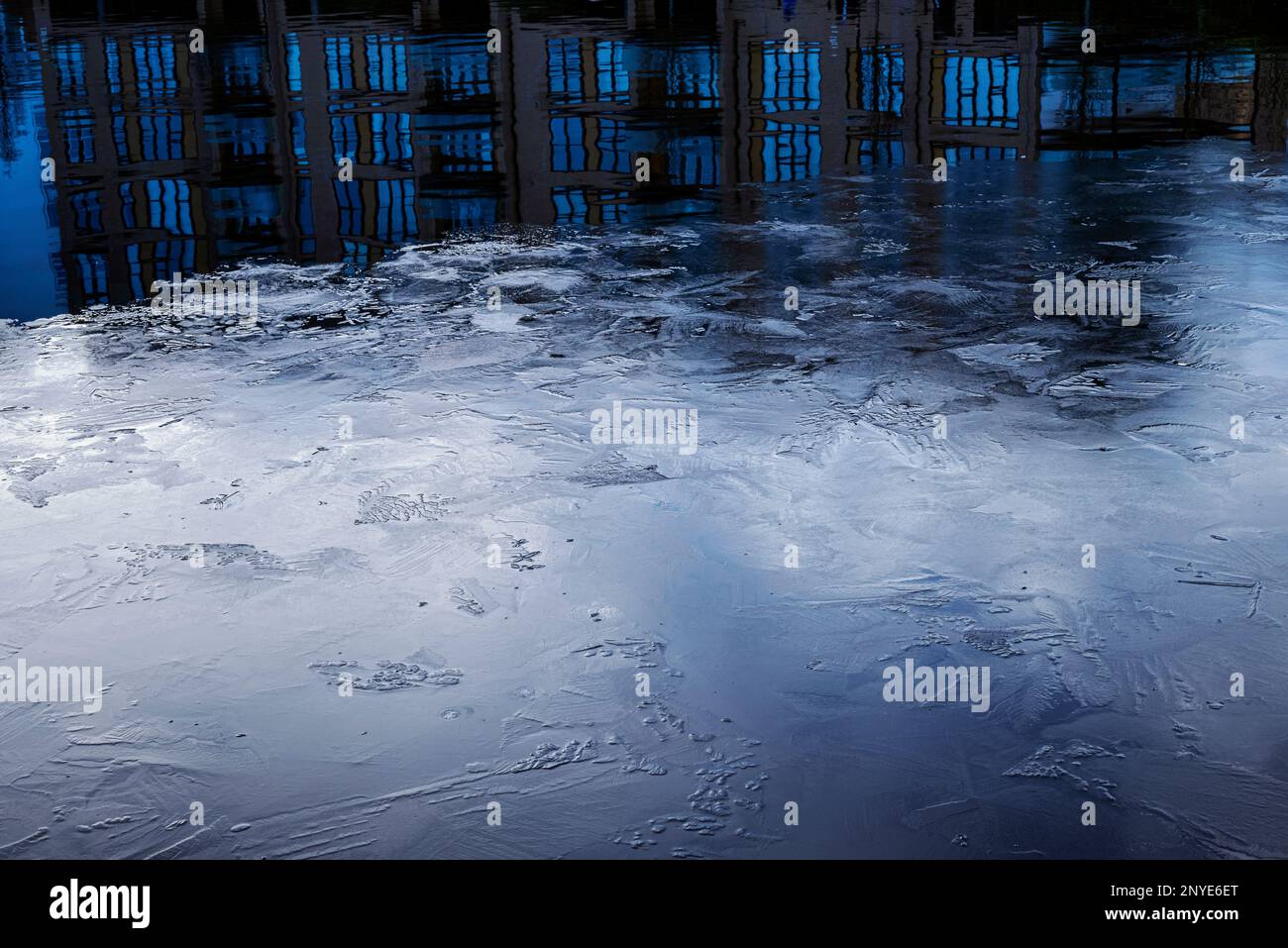 Surface of frozen lake with reflection Stock Photo - Alamy