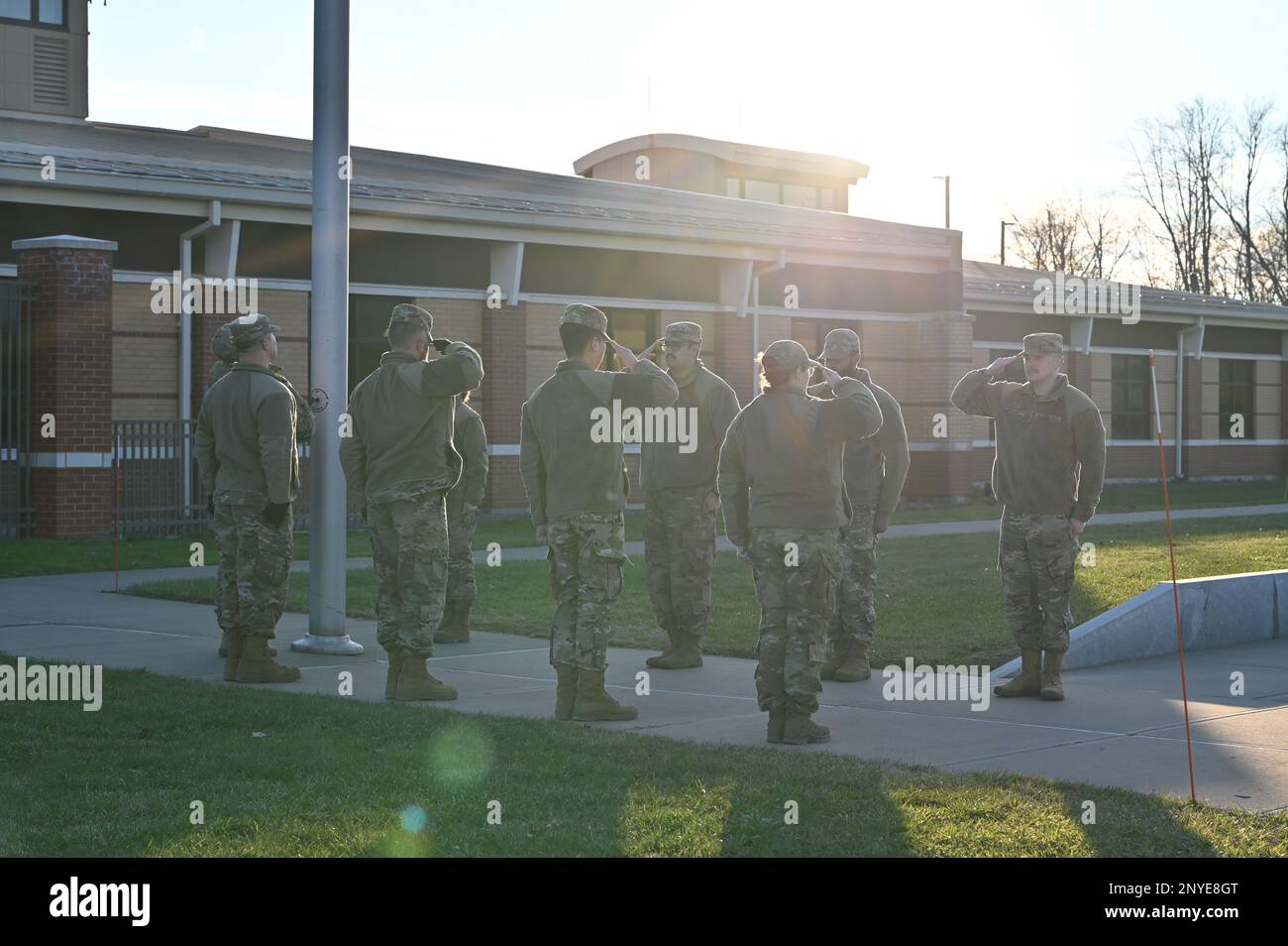 Members of the 174th Attack Wing lower and fold the flag during a ...