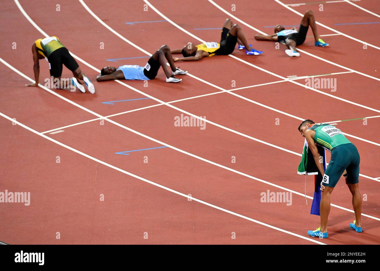 South Africa's Wayde Van Niekerk, right, rests after winning the Men's ...