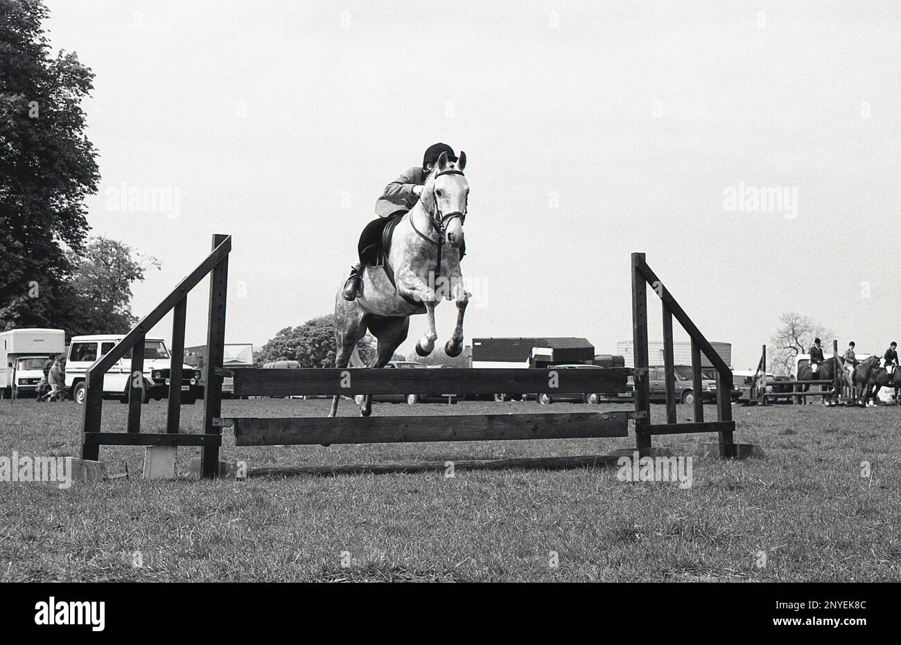 1989, show jumping, a youngster on a horse jumping a fence or obstacle ...