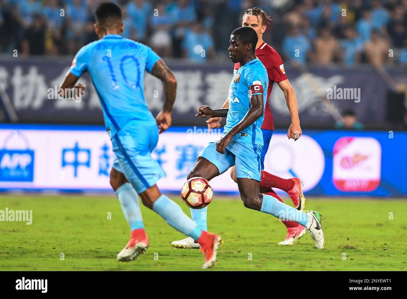 Brazilian football player Ramires, left, of Jiangsu Suning kicks the ...