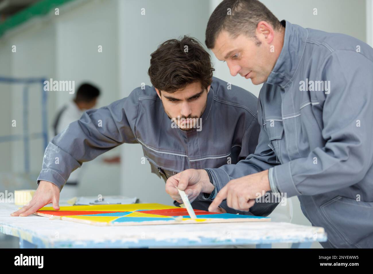 an apprentice learning painting technique Stock Photo - Alamy