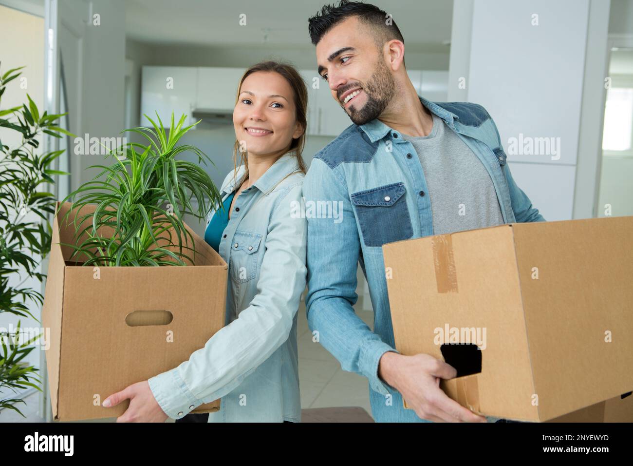 young couple carrying their boxes Stock Photo - Alamy