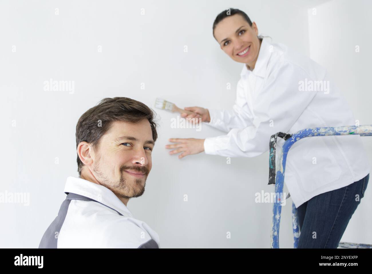 team of two professional male and female young painters Stock Photo - Alamy