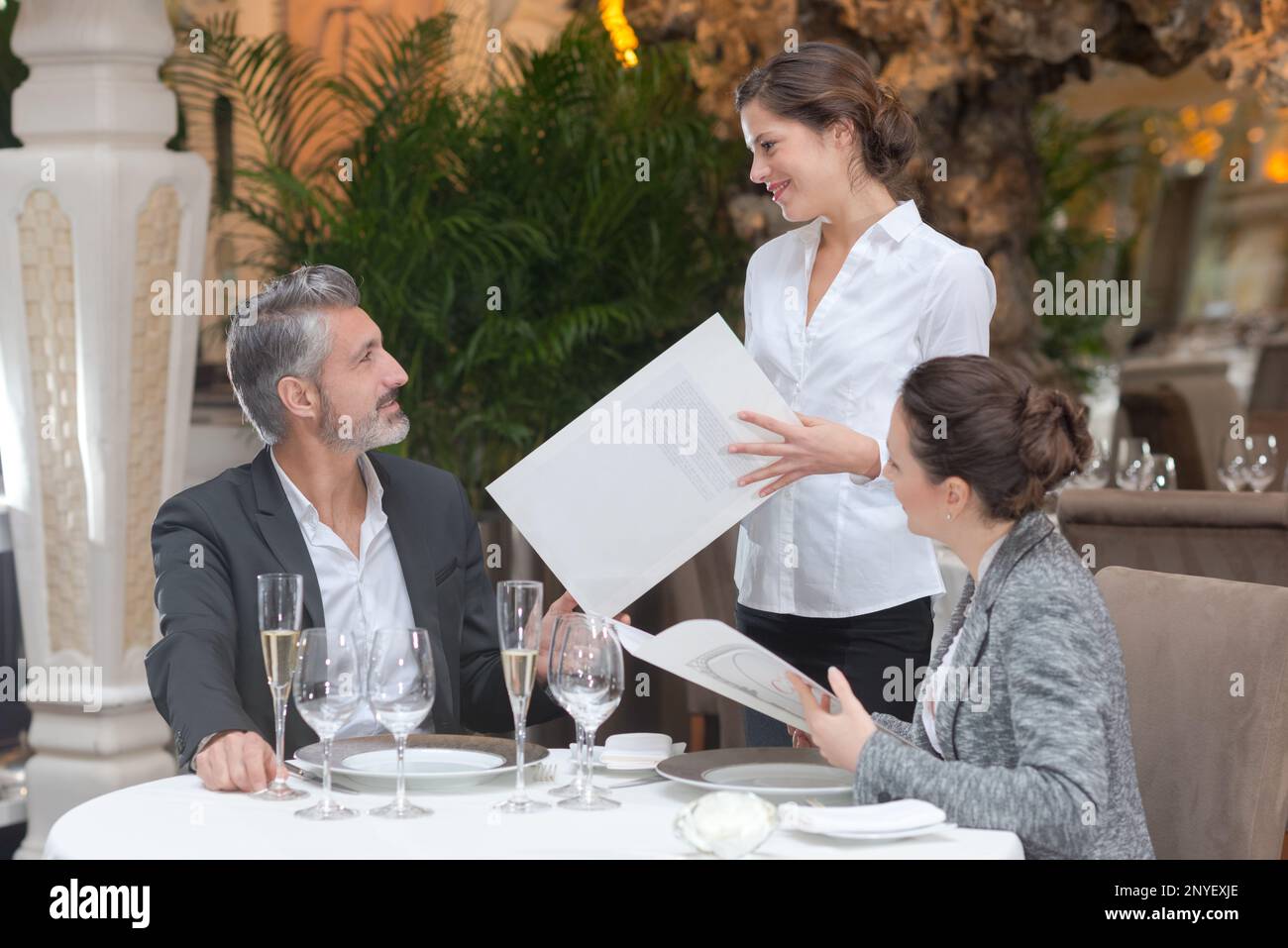 female waitress taking an order from a couple in restaurant Stock Photo ...