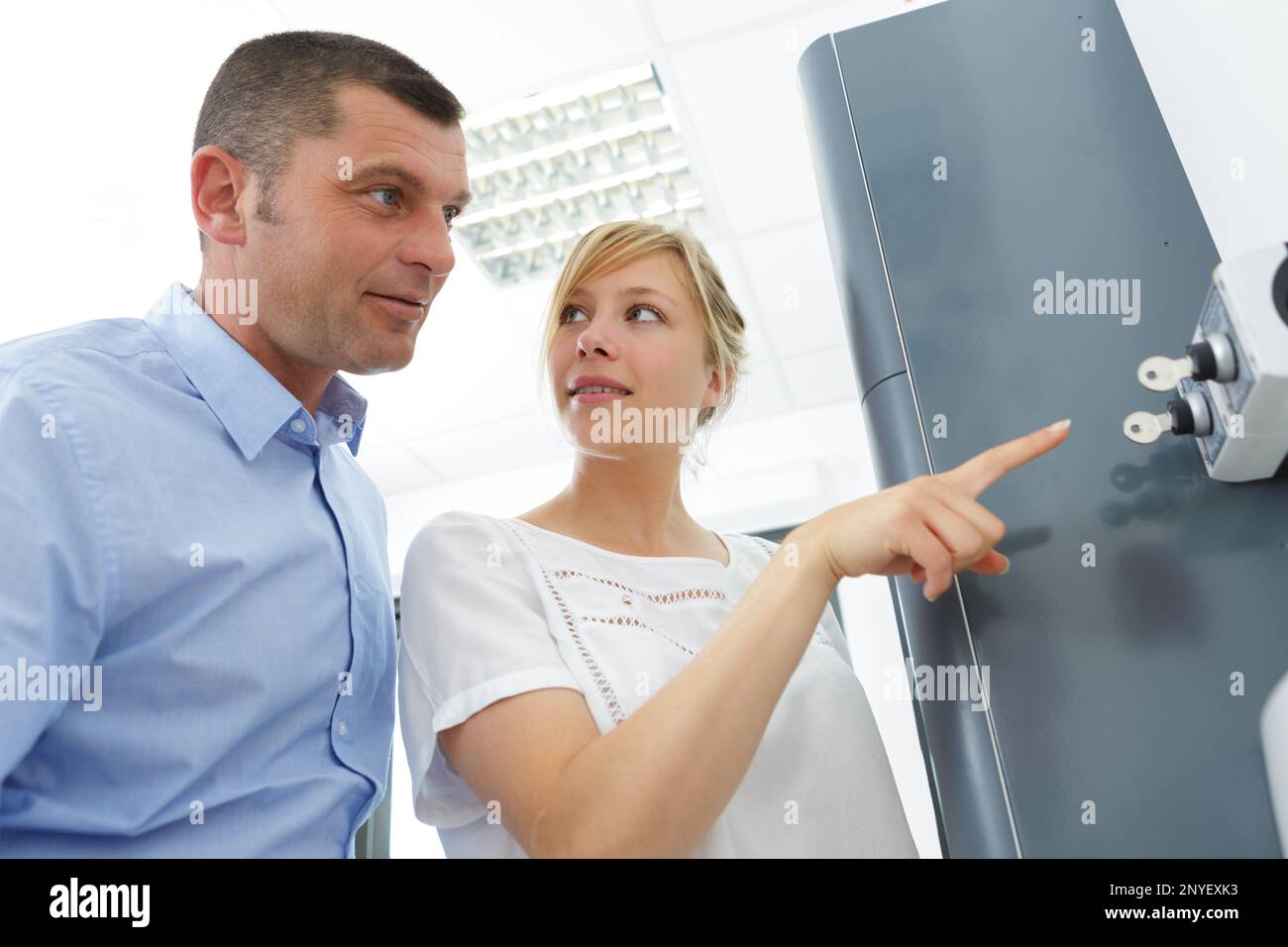 two workers checkin secuity system Stock Photo - Alamy