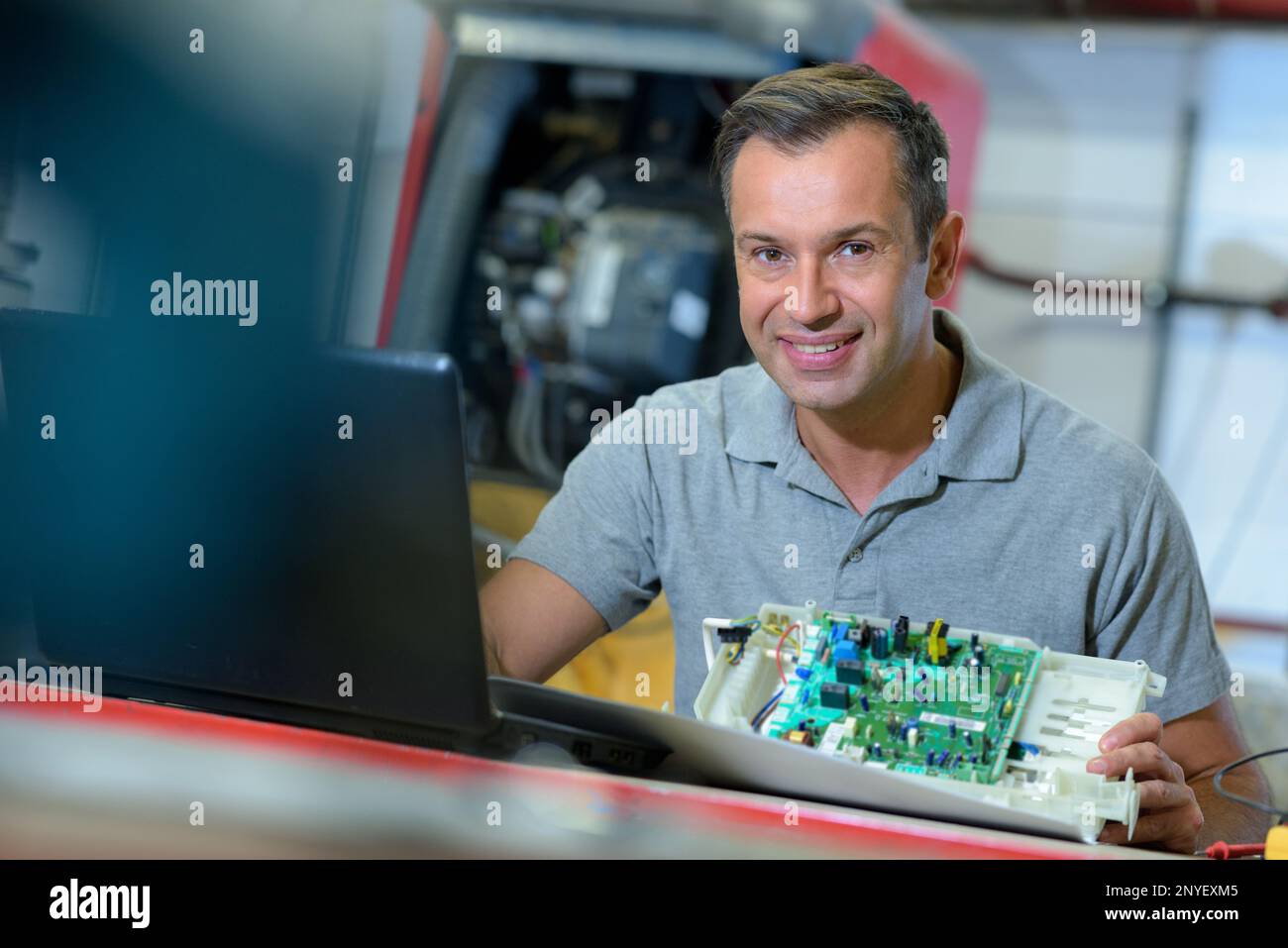 technician takes a computer board with chips Stock Photo - Alamy