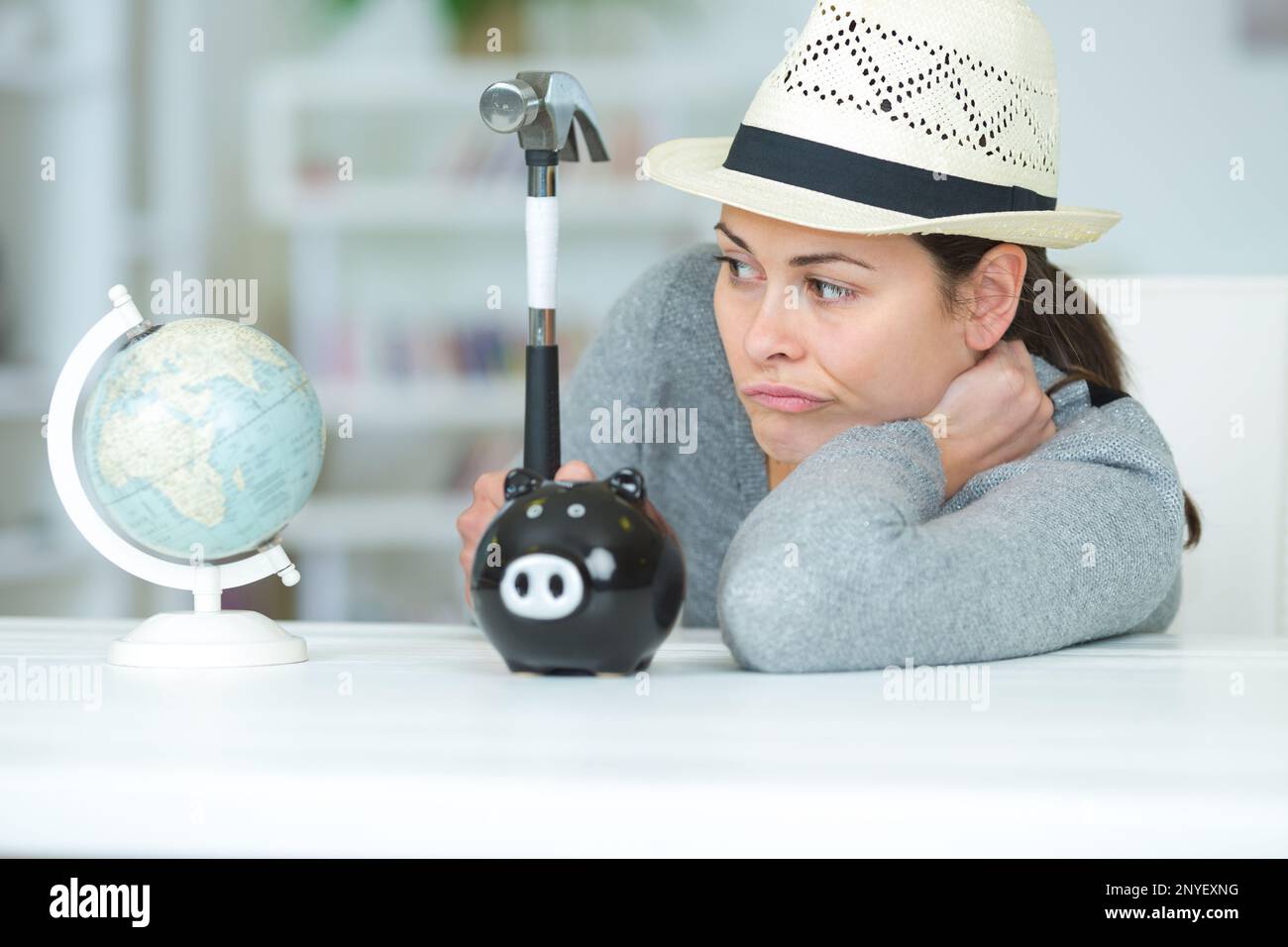 young woman smashed piggy bank with a hammer Stock Photo - Alamy
