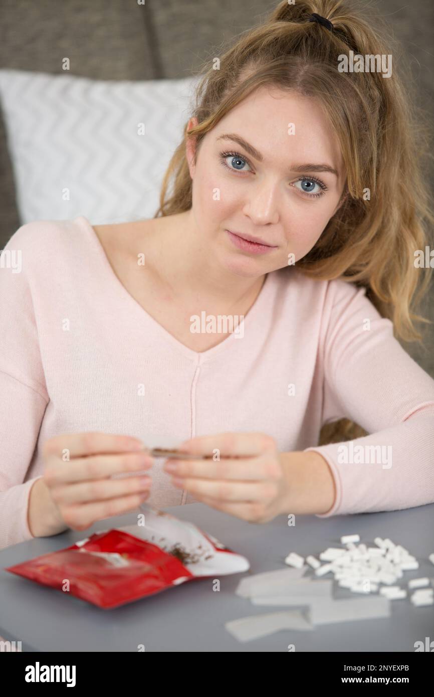 a woman making a cigarette Stock Photo - Alamy
