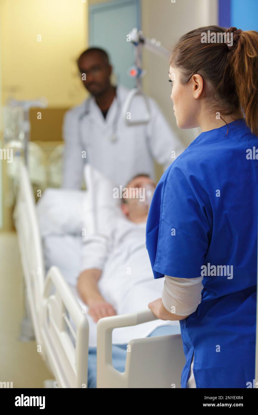 patient hospital bed moved by medical staff to operating room Stock ...