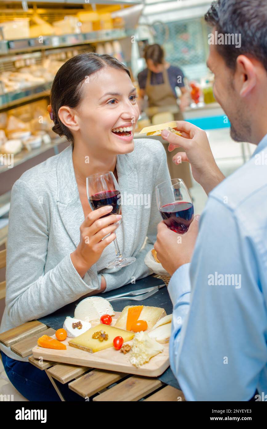 a couple is snacking in supermarket Stock Photo - Alamy