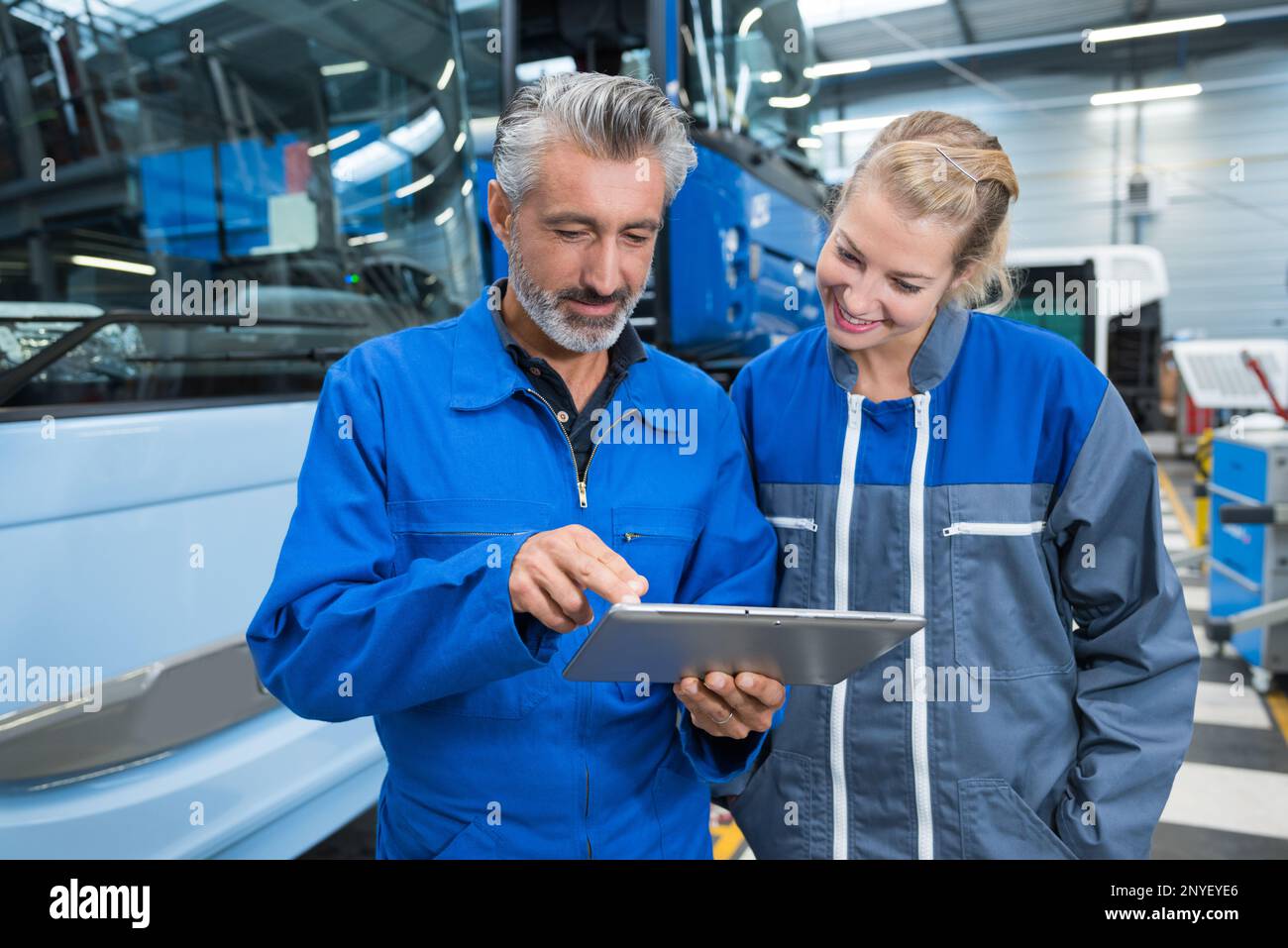 bus company maintenance team studying a defect from tablet Stock Photo ...