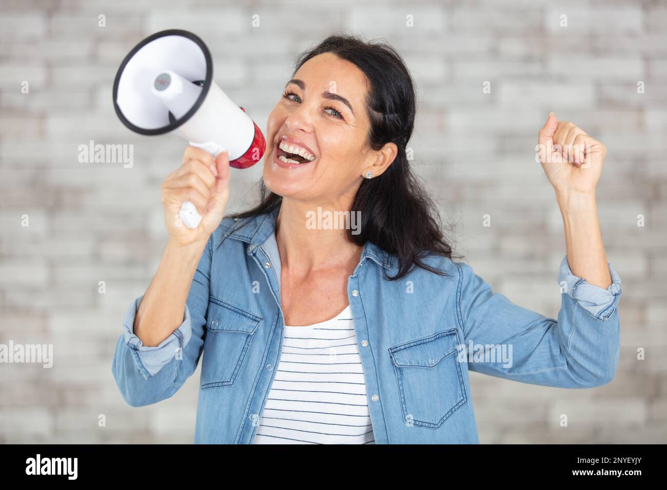 happy mature woman talking through a megaphone Stock Photo - Alamy