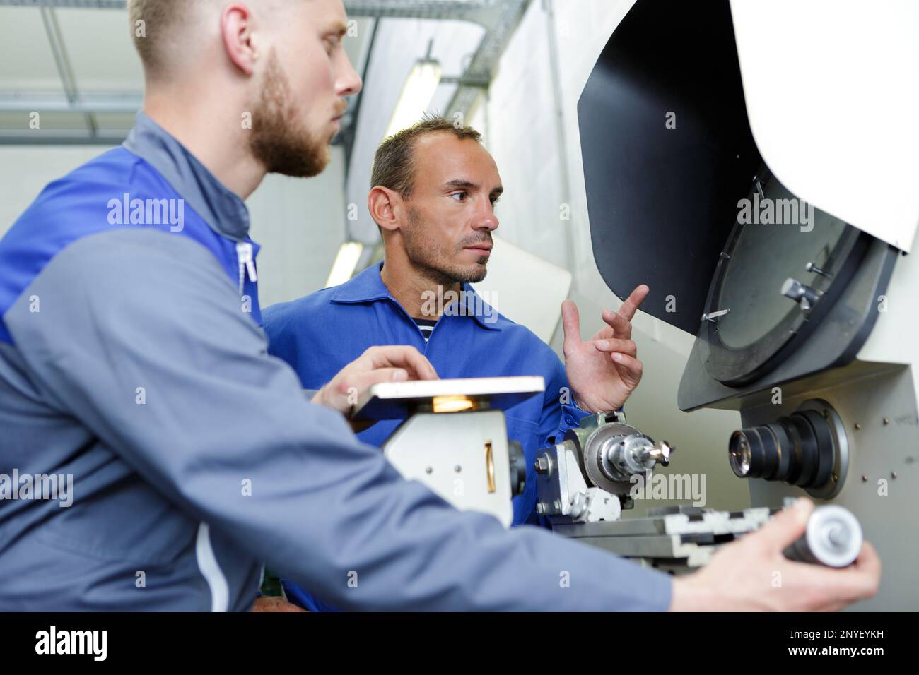 two male engineers using equipment Stock Photo - Alamy