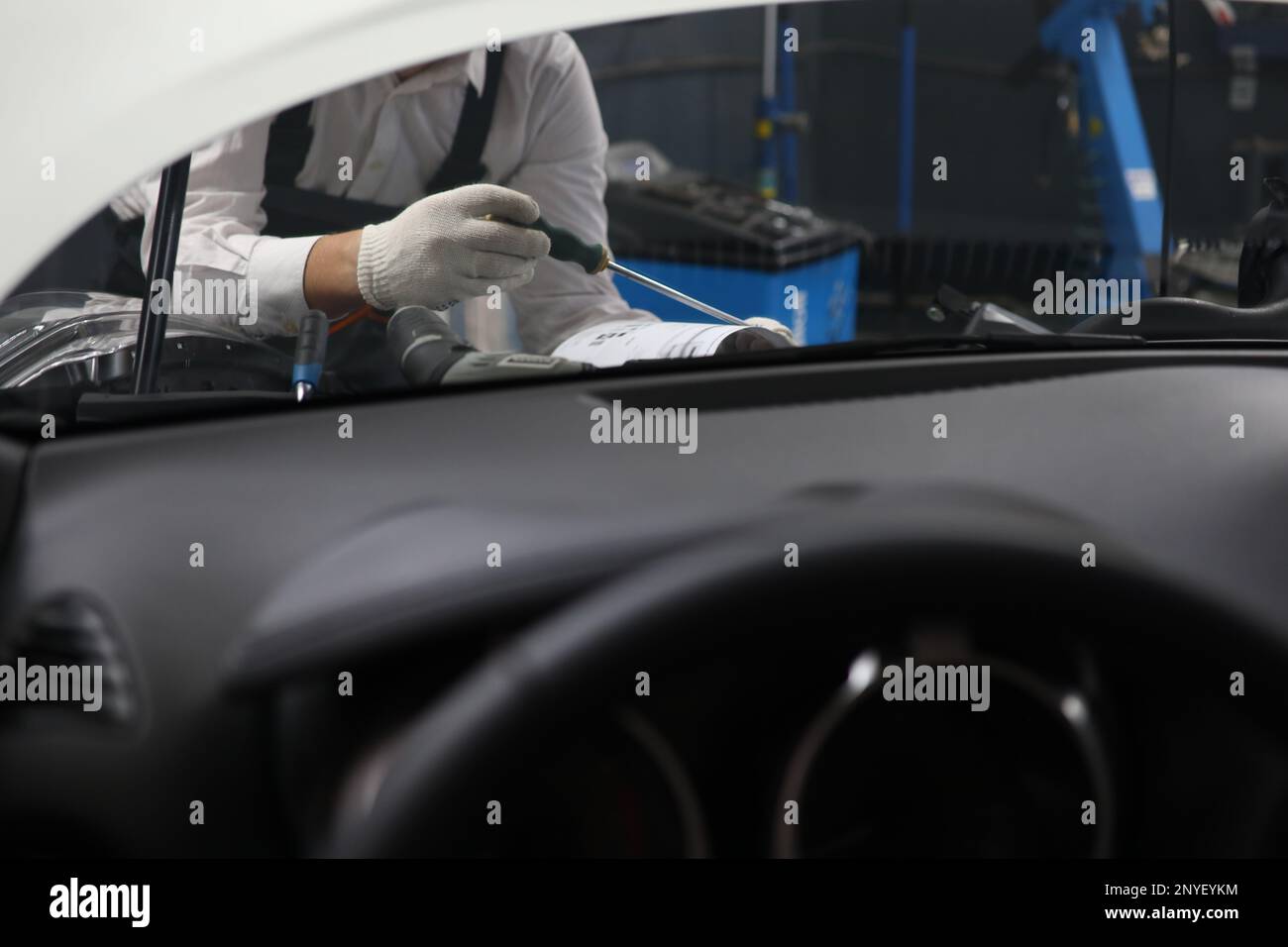 Mechanic checks engine and cooling system in car workshop Stock Photo ...
