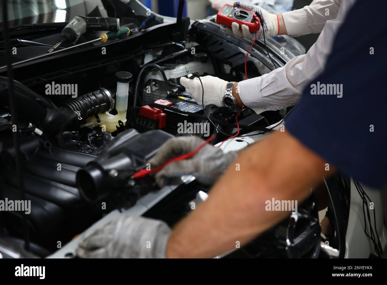 Professional auto mechanic works in a car service and tests operation ...