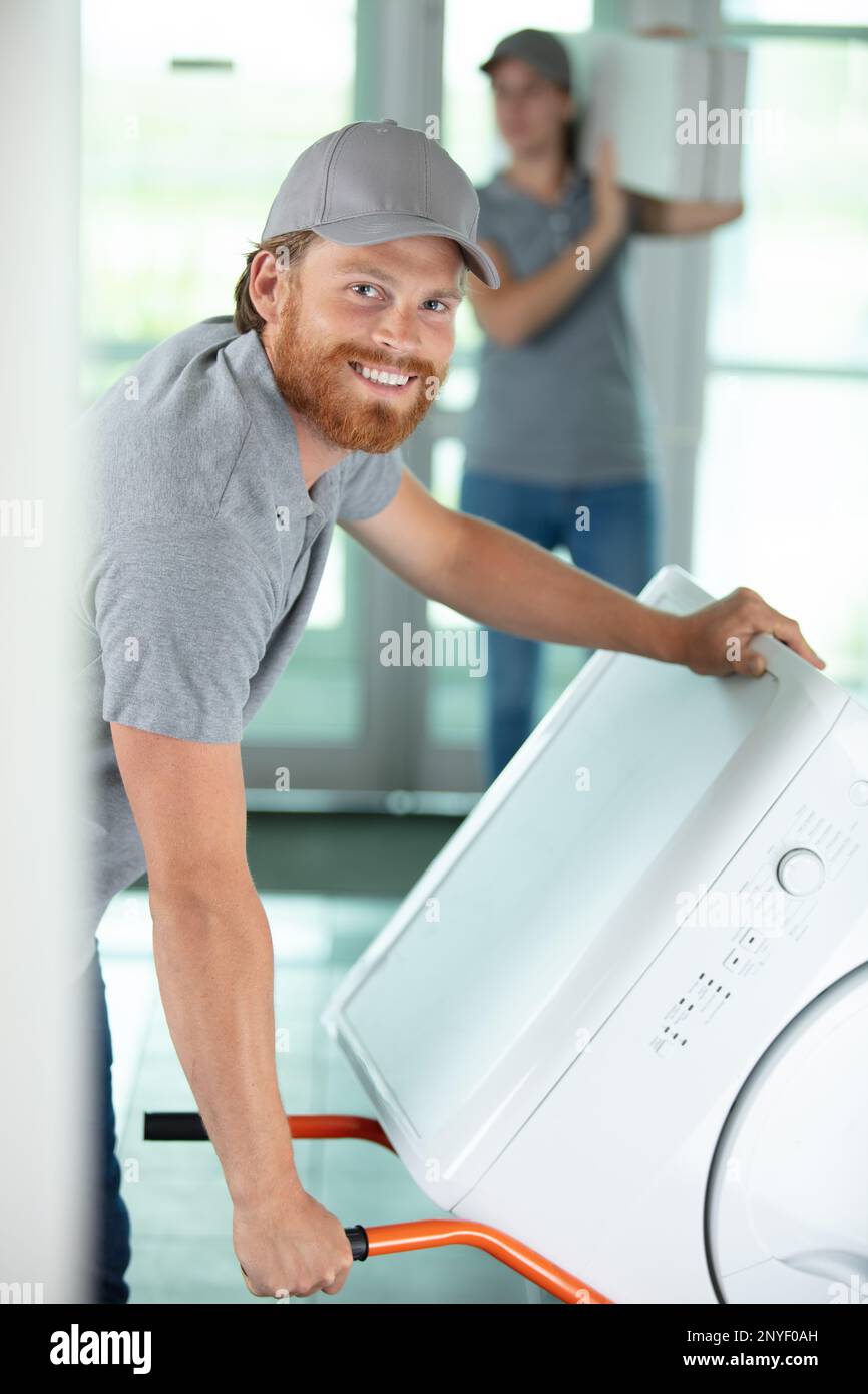 Man carrying washing machine hi-res stock photography and images - Alamy