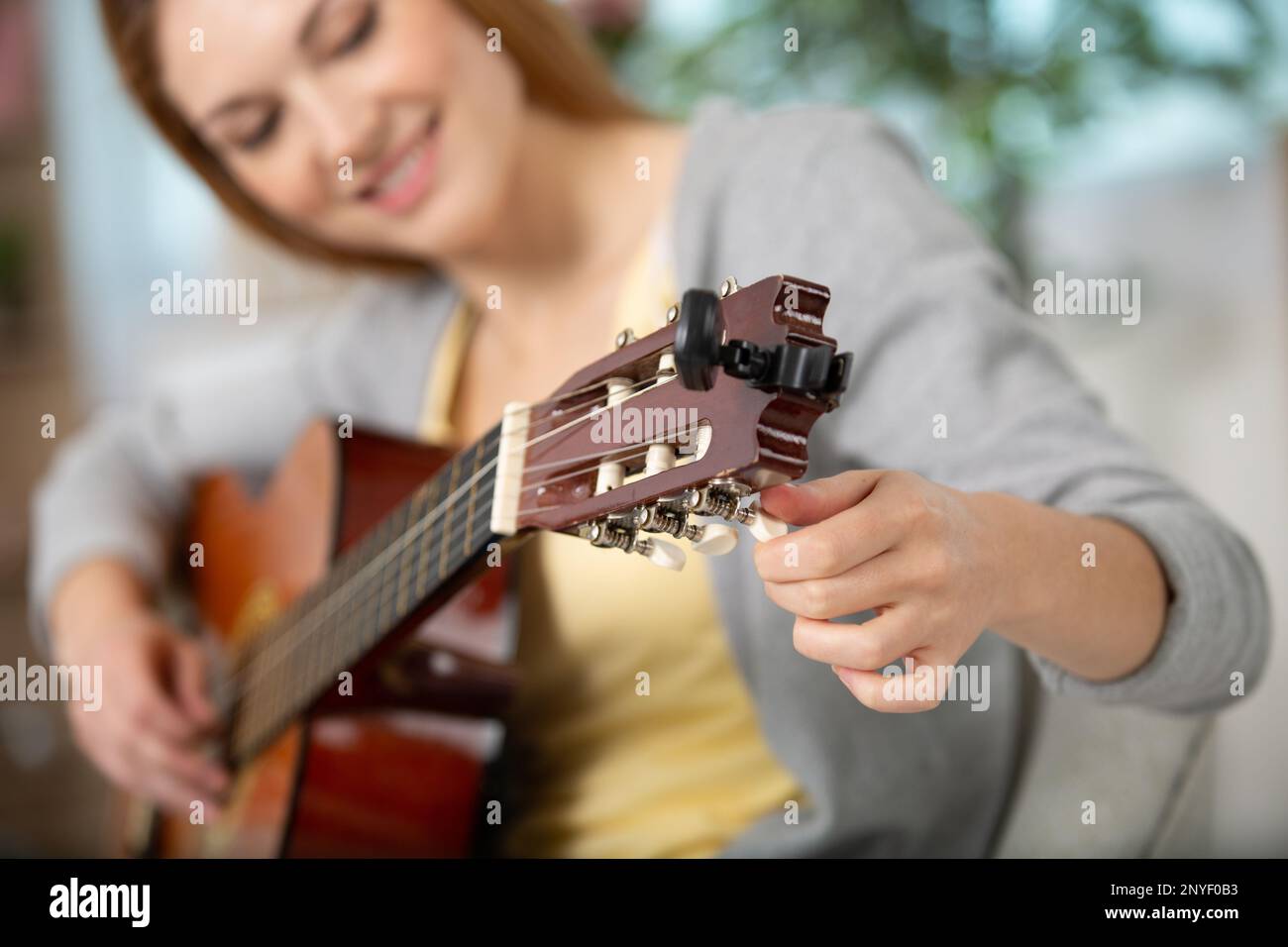 happy girl playing guitar and singing Stock Photo - Alamy
