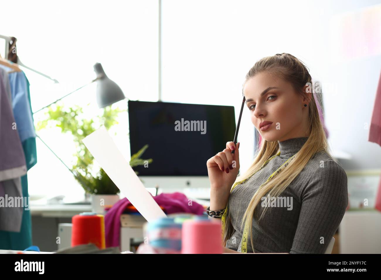 Portrait of professional fashion designer drawing new sketch of ...