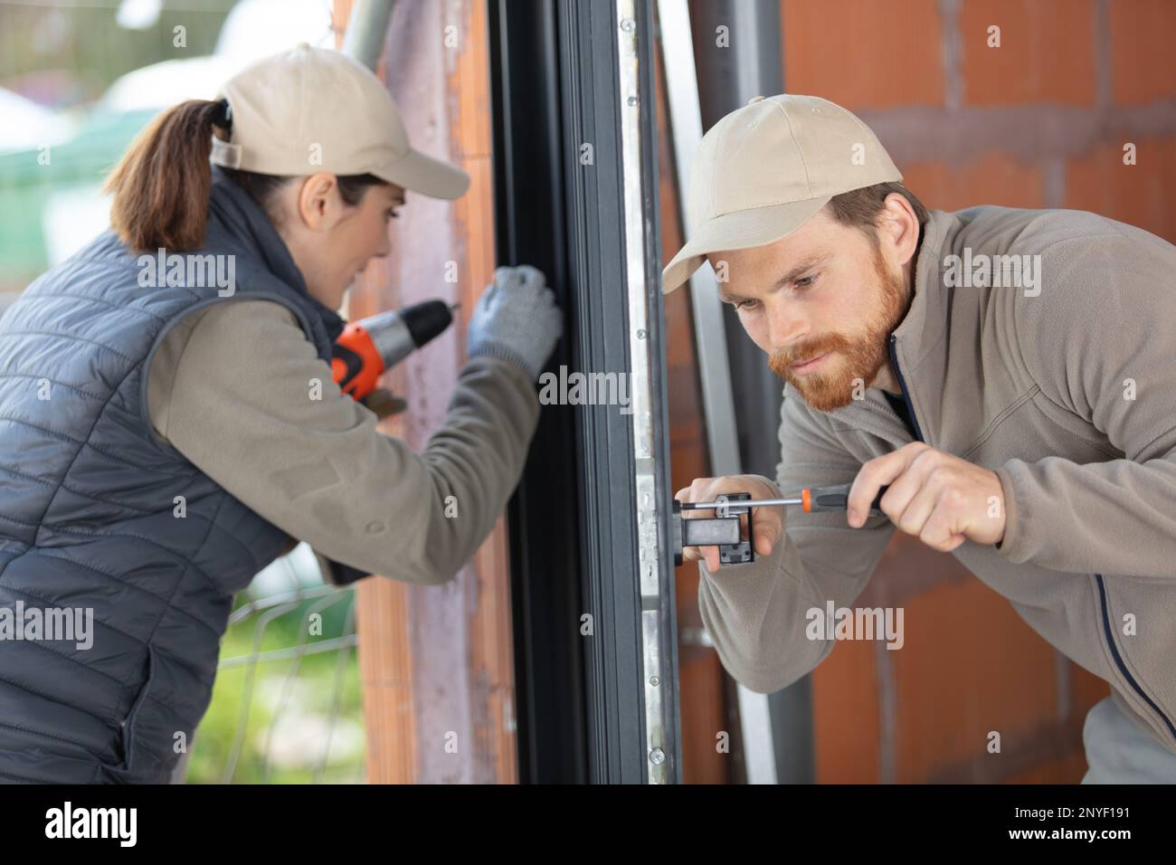 two builders male and female on construction project Stock Photo - Alamy