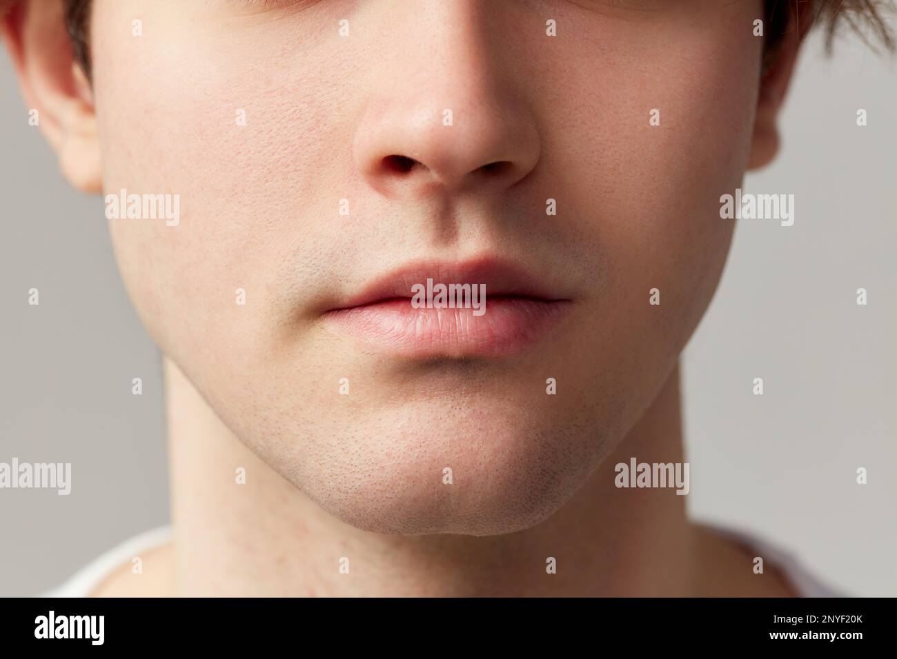 Cropped image of male face nose, lips, chin. Young model posing over ...