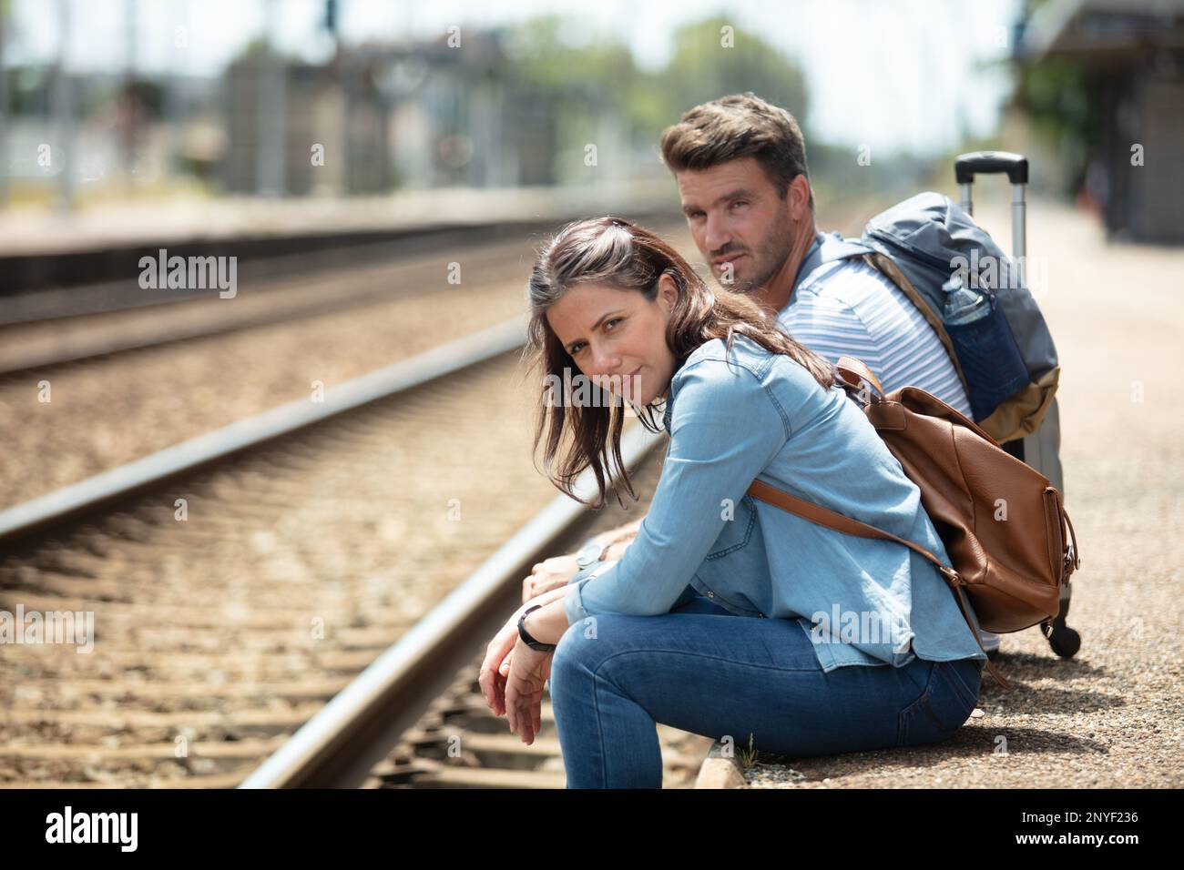 two people waiting at the train station Stock Photo - Alamy