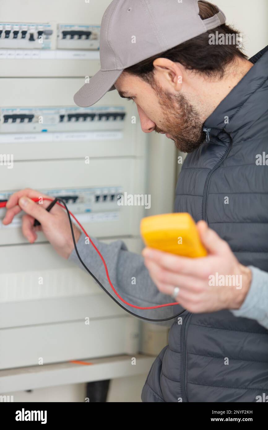 electrician installing energy saving meter Stock Photo - Alamy