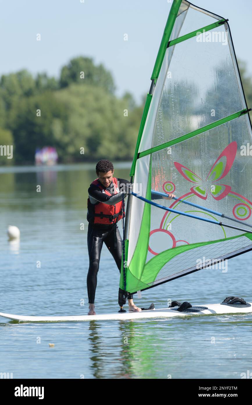 a man is windsurfing on a lake Stock Photo - Alamy