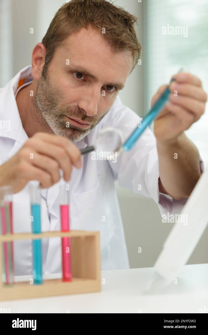 Doctor magnifying glass checking hi-res stock photography and images ...