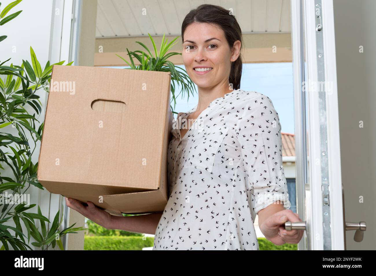 woman while moving into house Stock Photo - Alamy