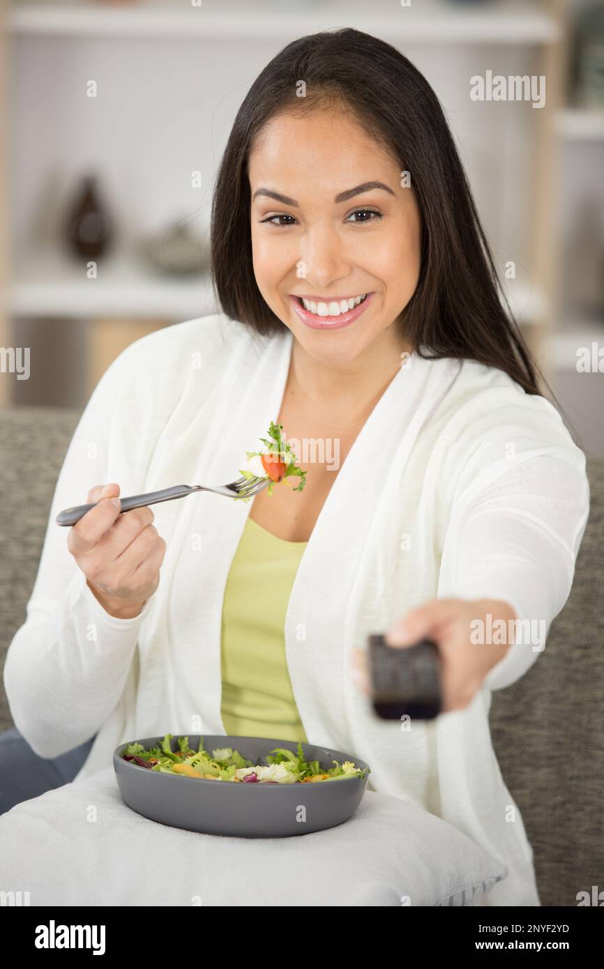 adorable pretty beautiful woman watching tv while having lunch Stock ...