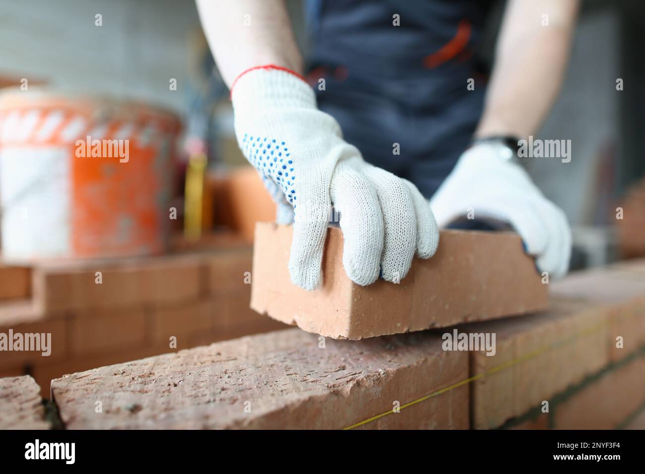 Closeup hands of bricklayer laying brick wall of house Stock Photo - Alamy